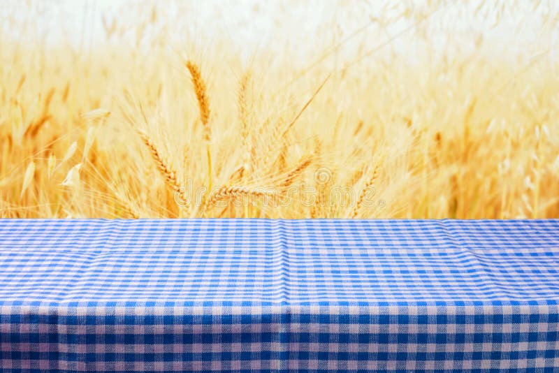 Table with Tablecloth Over Wheat Field Background Stock Image - Image ...