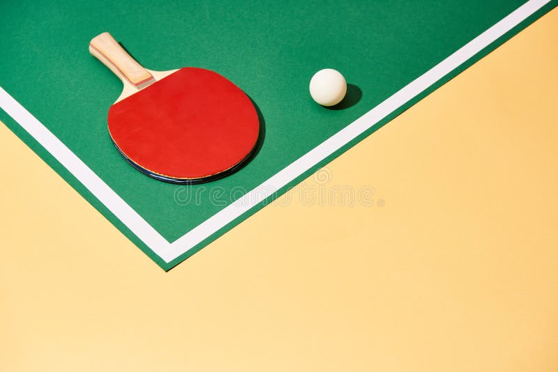Table Tennis Racket and Ball on Green and Yellow Surface Stock Photo ...