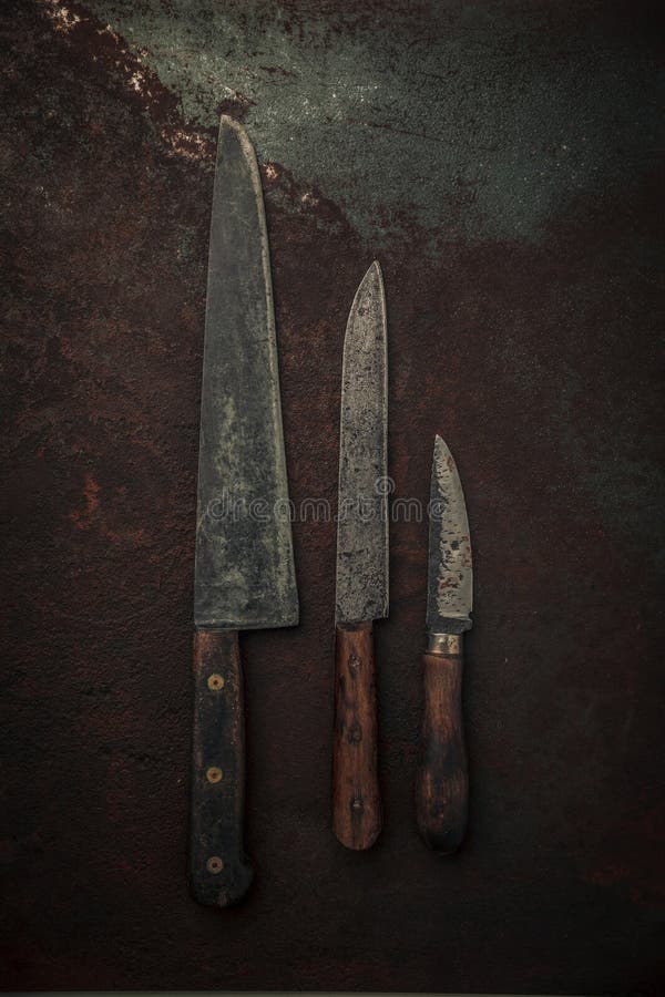 Table Top View of Three Rustic Knives on Old Rusty Metallic Background ...