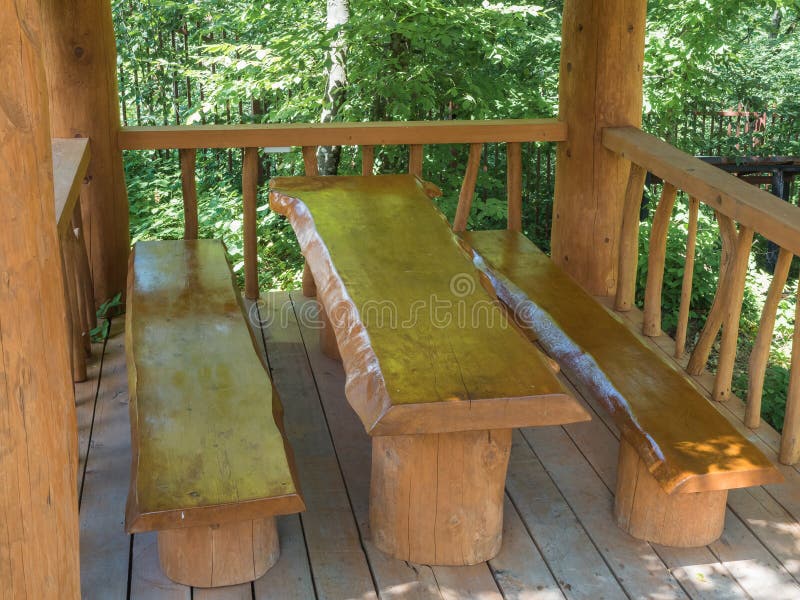 A Table and Two Benches Made of Large Solid Wood in Log Cabin Stock ...