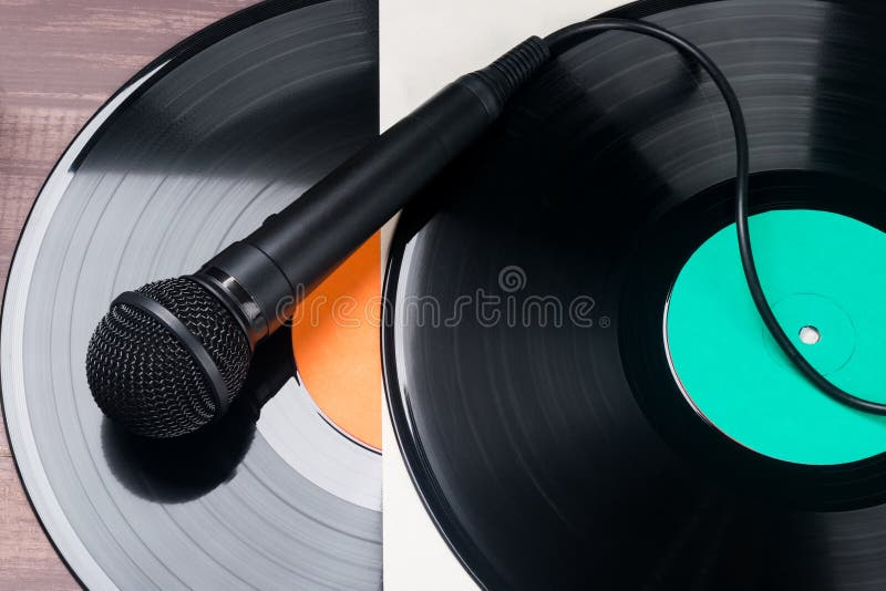 On the Table are Two Black Vinyl Records and a Microphone for Recording ...