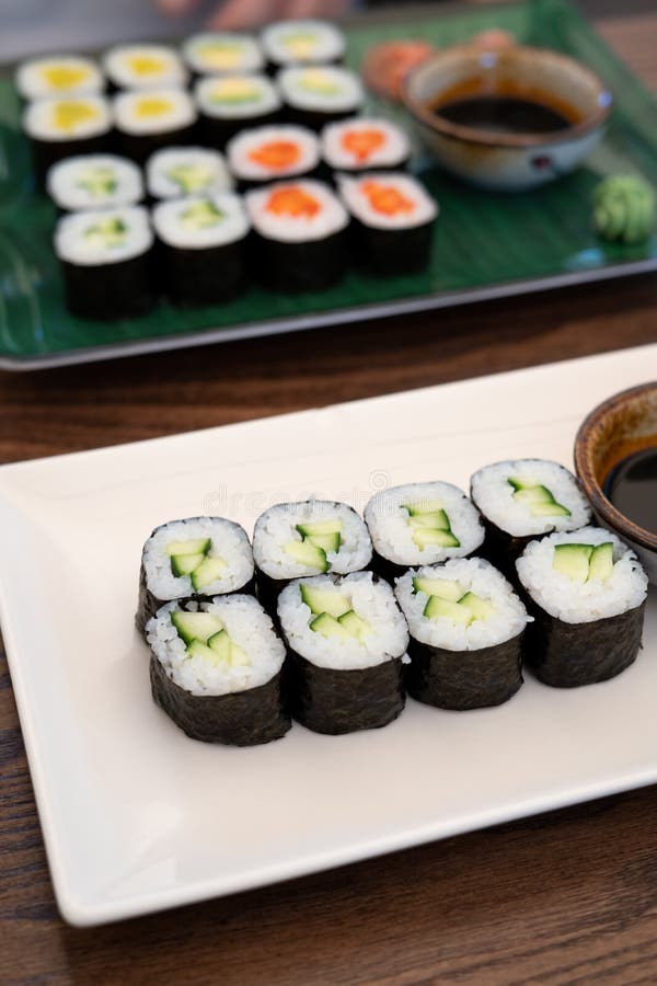A Table with Two Plates of Vegetarian Sushi, Side View Stock Photo ...
