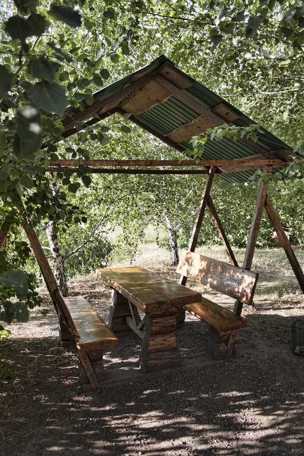 Table and Wooden Benches with a Roof Stock Photo - Image of house ...