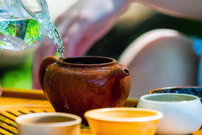 On the Table on a Wooden Tray a Teapot with Tea, Teapot, Cups. Man ...