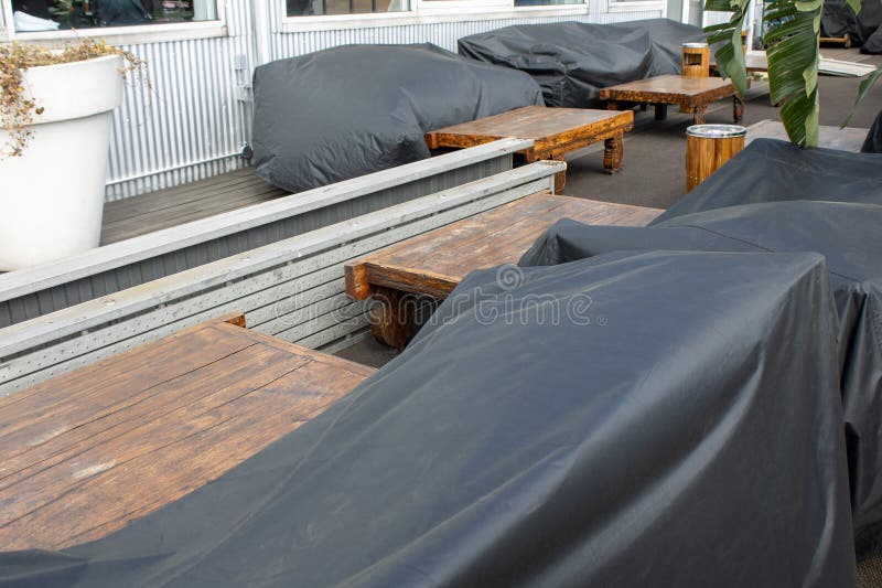 A Group of Tables and Chairs Covered with Cover on Patio Area Editorial ...