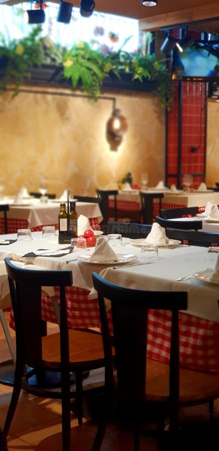 Tables in a restaurant editorial stock photo. Image of lunch - 128699768