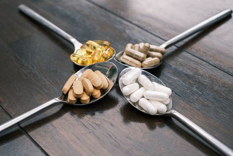 On Four Tablespoons There are Different Tablets and Pills Stock Photo ...