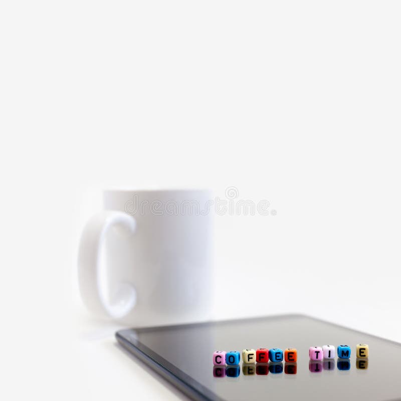 Tablet with Alphabet Coffee Time Cube Blocks on it and a Cup of Coffee ...