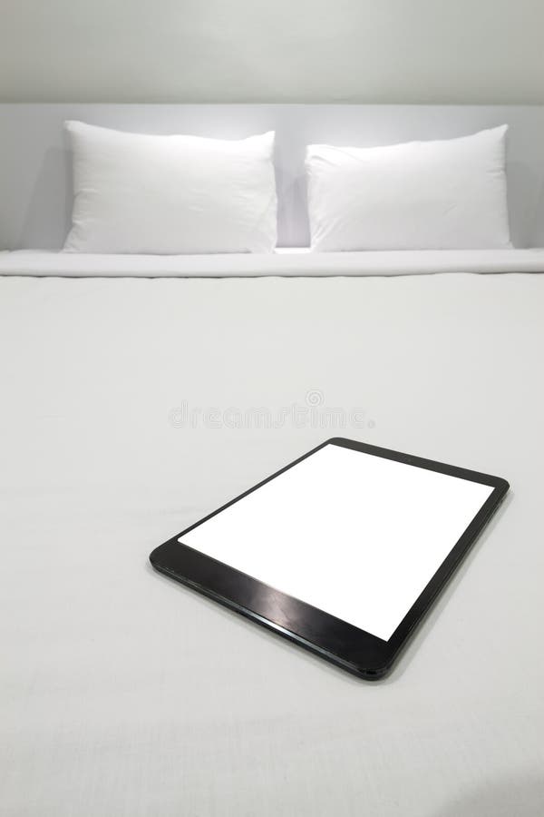 A tablet on a bed stock image. Image of comfortable, room - 76517647