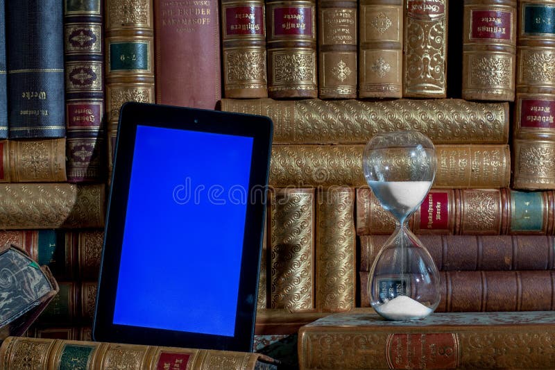 Tablet with Blue Screen with Old Books in Background Stock Photo ...