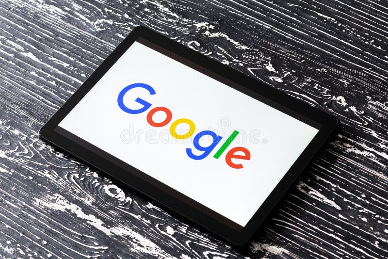 Tablet Computer on a Black Wooden Table with a Search System Google ...