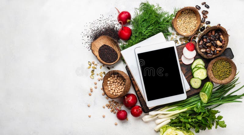 Tablet Computer with Blank Screen and Notebook with Fresh Vegetables on ...