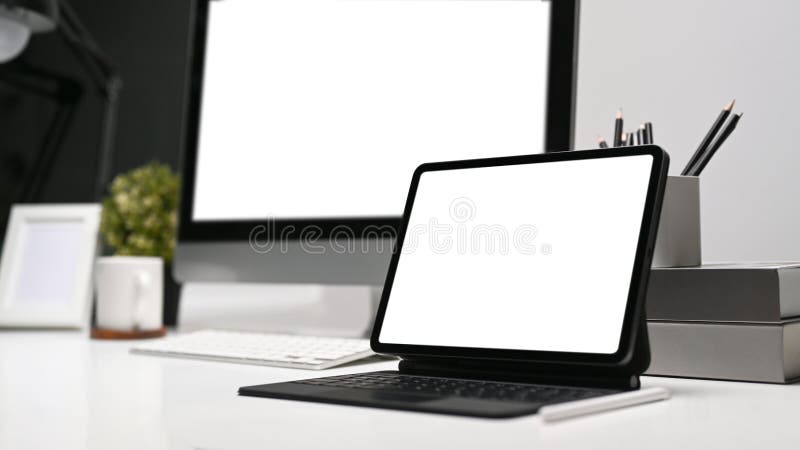 A Tablet Computer with Keyboard Case and Computer on Modern Workstation ...