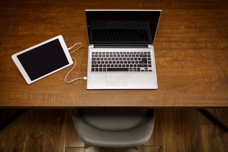 Tablet Connected with Laptop on Desk Stock Photo - Image of device ...