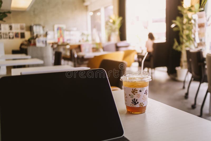 Tablet and Cup of Iced Coffee in the Cafe. Concept of Working in the ...