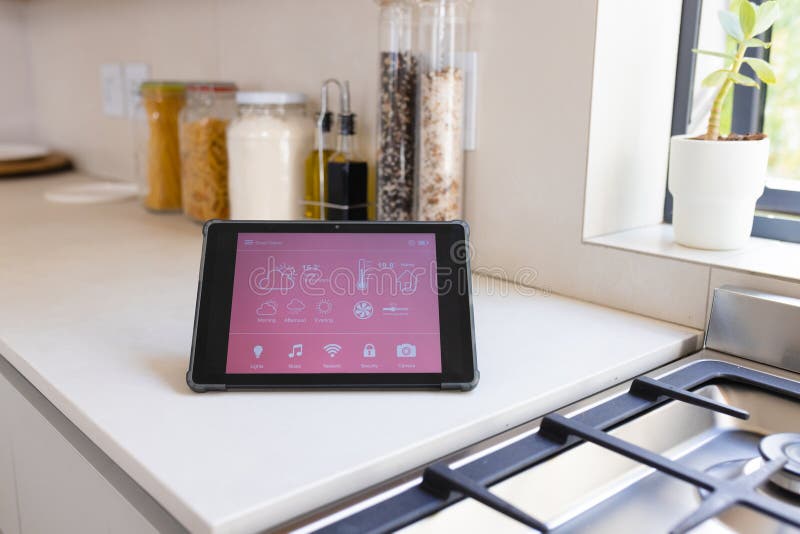 A Tablet Displaying Smart Home Interface Rests on a Kitchen Counter at ...