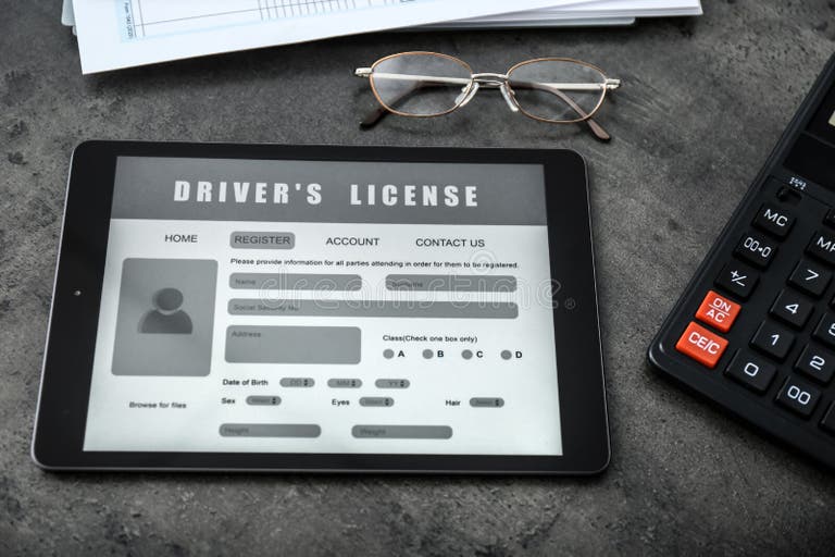 Tablet with Driver`s License Application Form, Glasses and Calculator ...