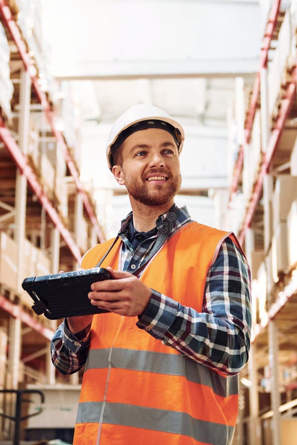 With Tablet. Employee in Uniform is Working in the Storage at Daytime ...