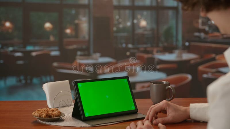 Tablet with Green Screen on Cafe Desk. Advertising Area, Workspace Mock ...
