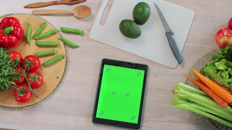 Tablet with Green Screen in the Kitchen on Table with Fresh Vegetables ...