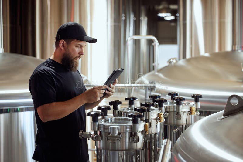 With Tablet in Hand, Brewery Technologist Checking the Brewing ...