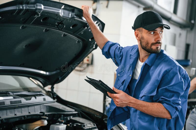 With Tablet in Hands. Auto Mechanic Working in Garage Stock Image ...