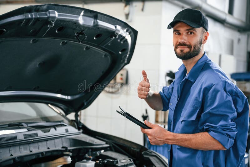With Tablet in Hands. Auto Mechanic Working in Garage Stock Image ...