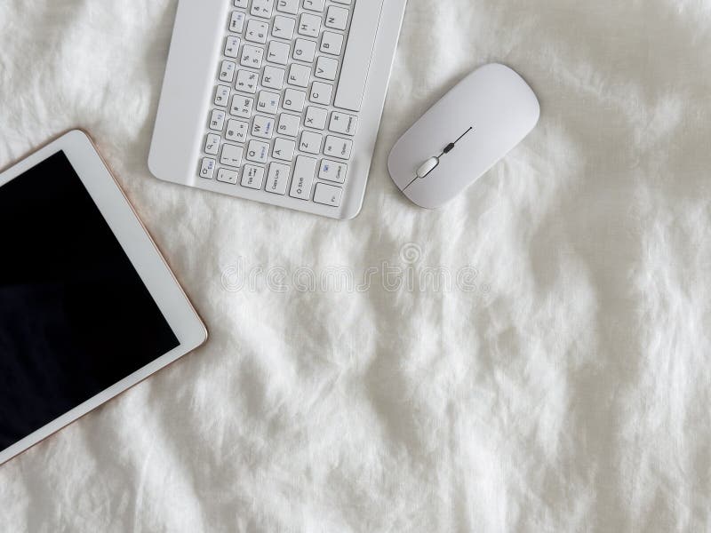 Tablet, Keyboard, Mouse on White Sheets in Bed, Top View. Online Home ...