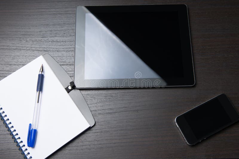 Tablet with Notebook and Pen on Dark Table Stock Photo - Image of ...