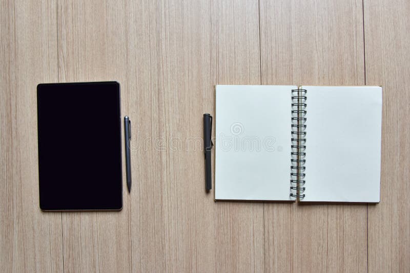 A Tablet and Notebook with Pens on Wood Table Stock Image - Image of ...