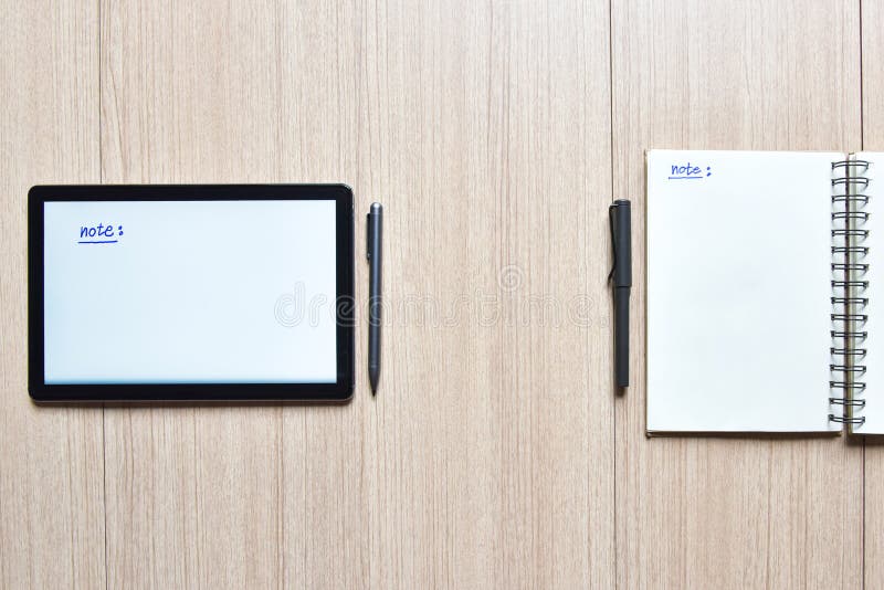 A Tablet and Notebook with Pens on Wood Table Stock Photo - Image of ...