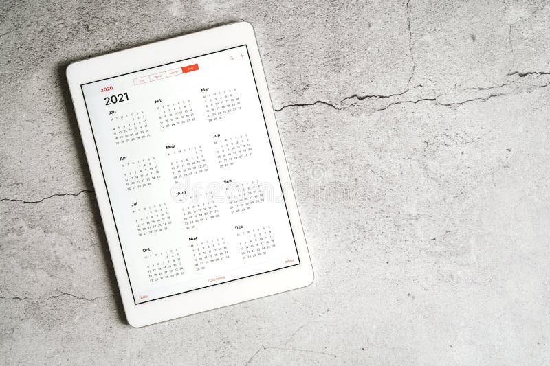 A Tablet with an Open Calendar for 2021 Year on a Gray Concrete ...