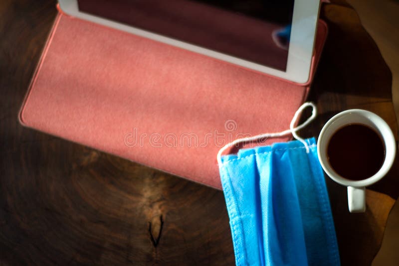 Tablet PC, Cup of Coffee and Face Mask Stock Photo - Image of covid19 ...