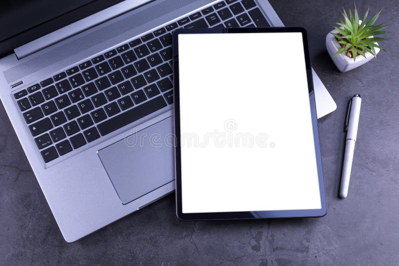 Tablet Pc Over Silver Laptop on Desk Stock Image - Image of technology ...