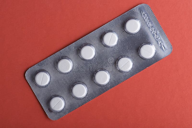 Tablet on red closeup stock image. Image of pain, pill - 12335099