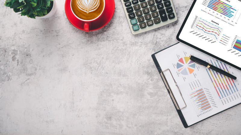 Tablet Screen Display with Charts and Reports on Office Desk Workplace ...