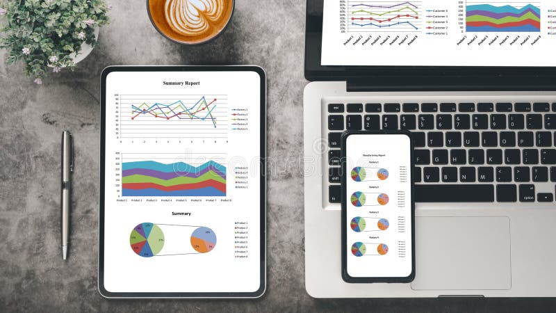 Tablet and Smart Phone with Charts and Reports on Office Desk Workplace ...