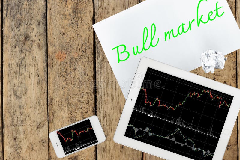 Tablet, Smartphone and Paper with Text Bull Market on Wood Table Stock ...