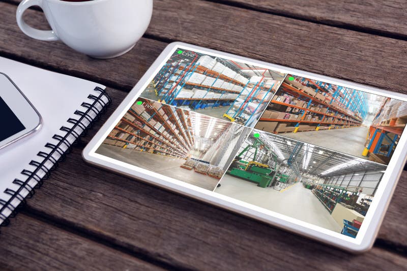 Tablet with View of Warehouse from Security Cameras on Screen Lying on ...