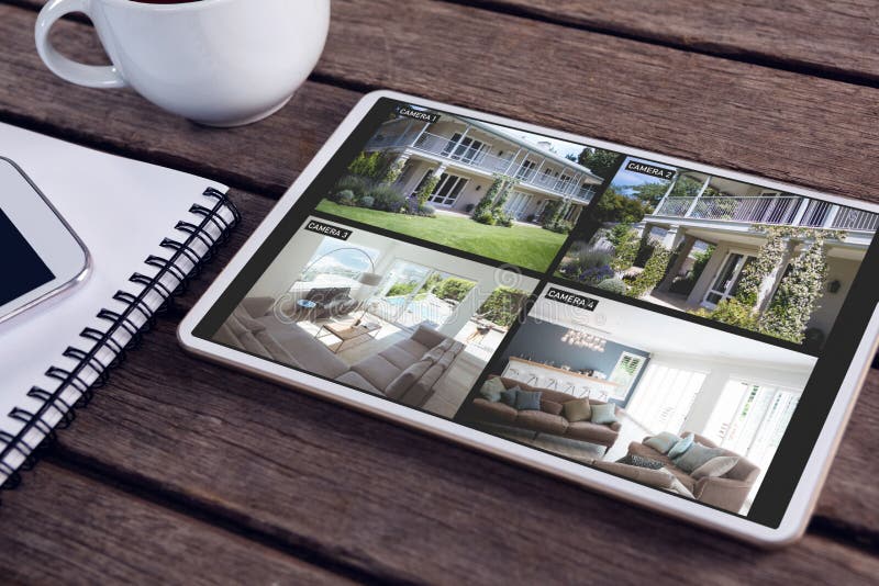 Tablet with Views of Home from Security Cameras on Screen Lying on ...