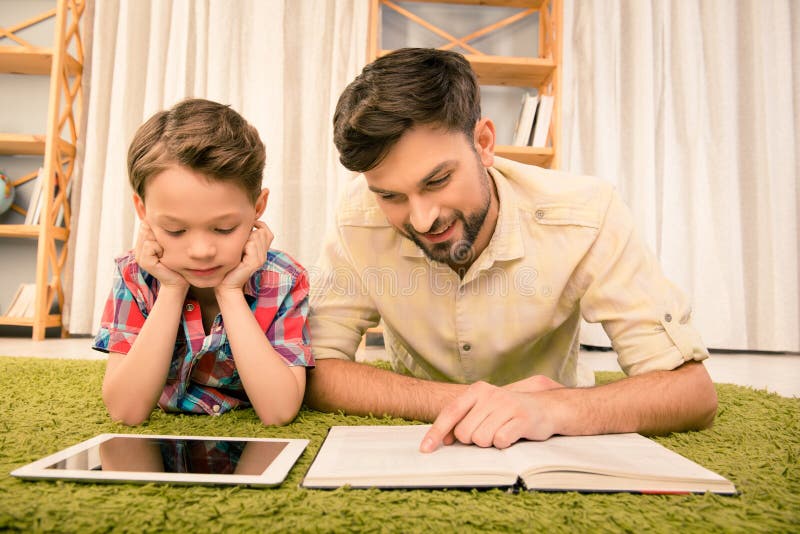 Tablet Vs Book. Father and His Little Son Reading Stock Image - Image ...