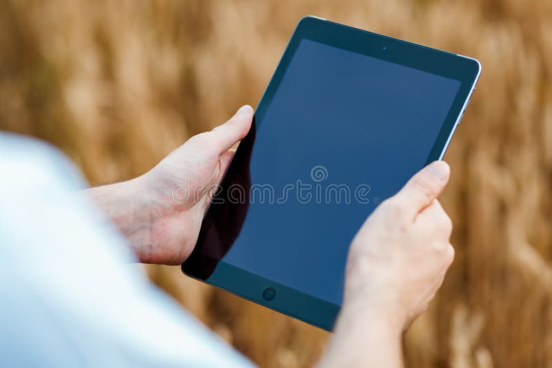 Tablet Which is Held by a Farmer Which is Standing in the Middle of a ...