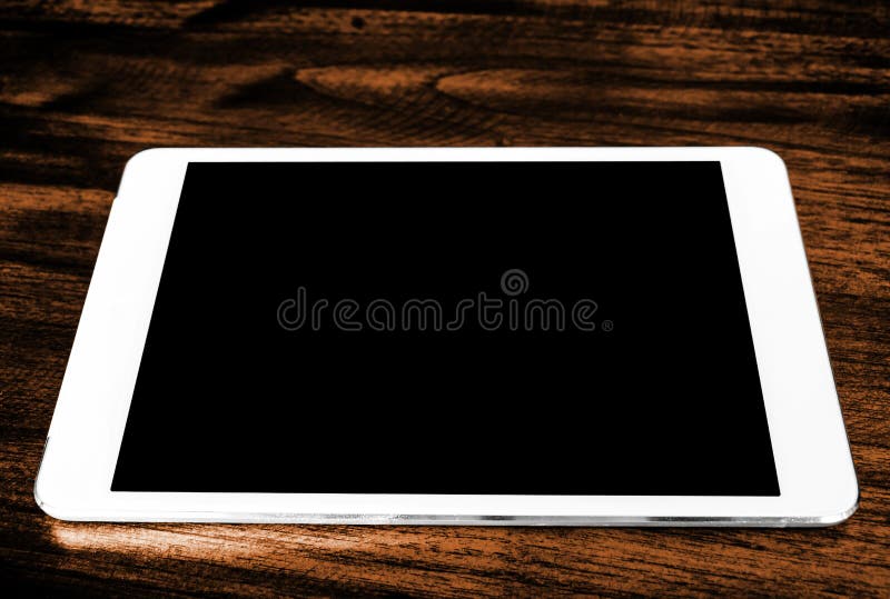 Tablet on wood table stock photo. Image of monitor, display - 33919790