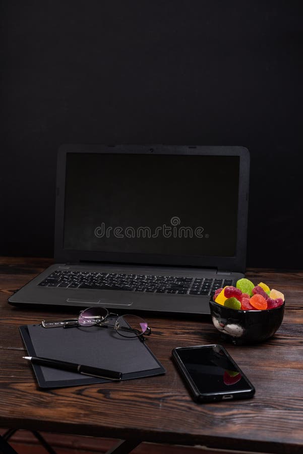Tablet for Writing and Laptop. Multi-colored Sweets on the Desktop ...