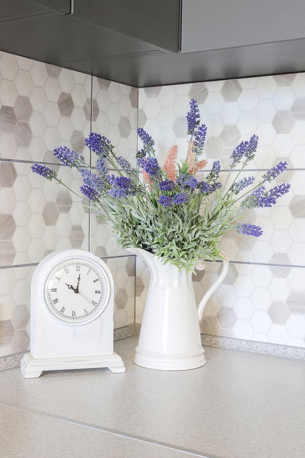 Tabletop Clock and Vase with Lavender Flowers on the Table Stock Photo ...