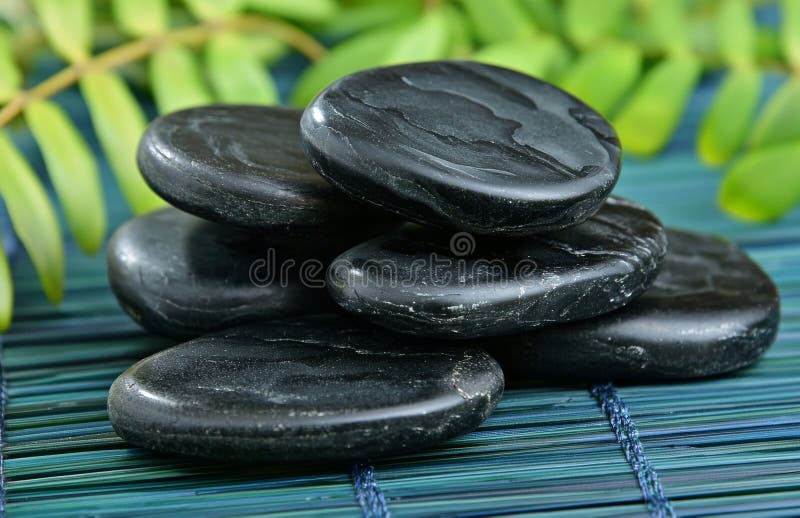 In a Tabletop Stack are Smooth Black Rocks with Bamboo Branches Stock ...