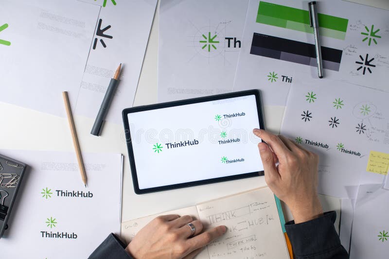 Tabletop View of a Logo Design Process, Featuring Sketches, Colour ...