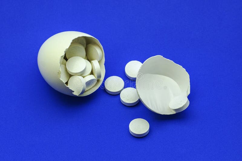Tablets in a Broken Chicken Egg on a Blue Background Concept Medicine ...