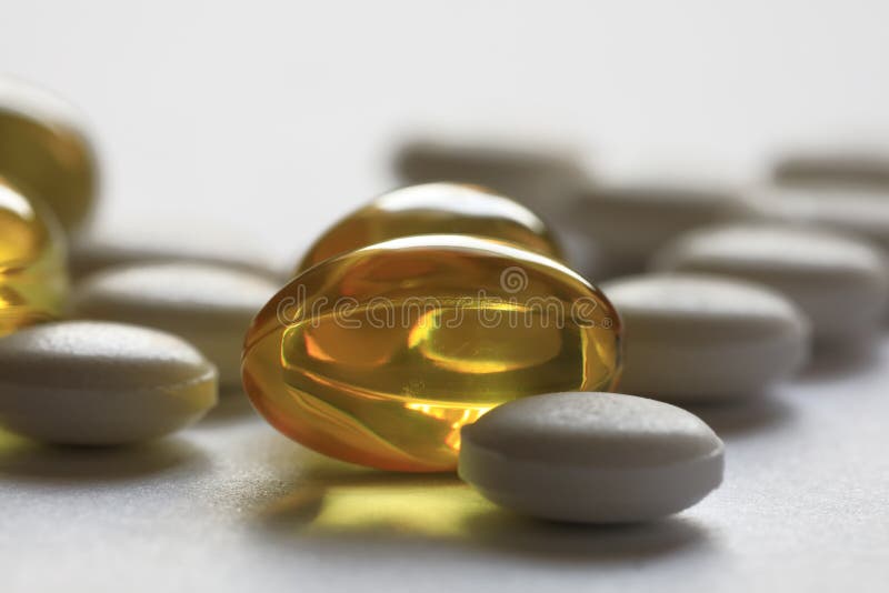 Some Tablets and Capsules on White Paper Stock Photo - Image of cure ...