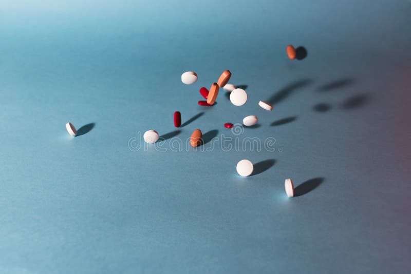 Tablets Falling Down on Blue Background Stock Photo - Image of nurse ...